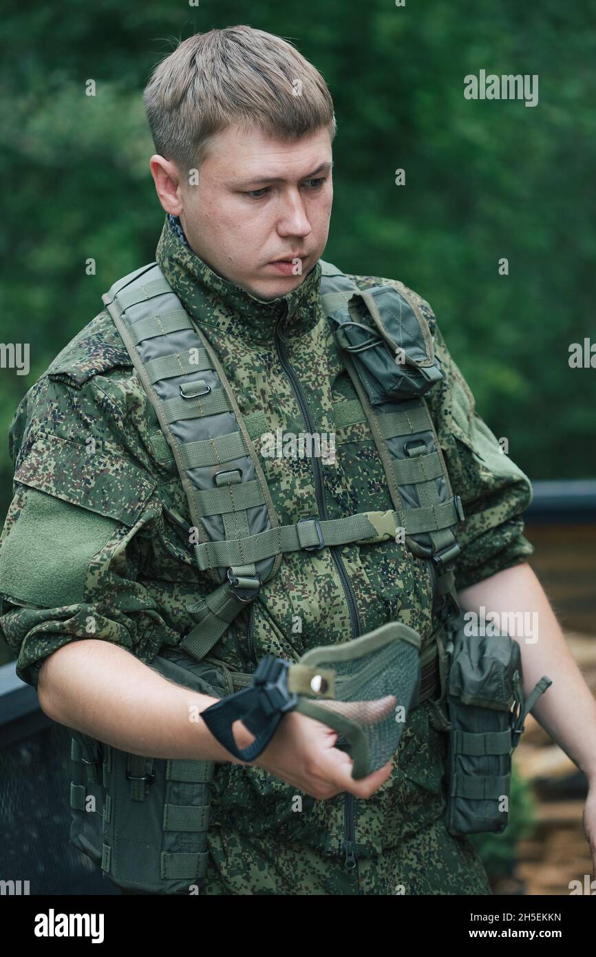 Fully equipped military men with automatic weapons getting ready to ...