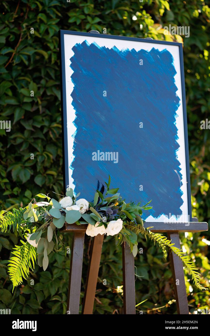 Wedding decorations. Wooden board with fresh flowers for events. Wooden ...