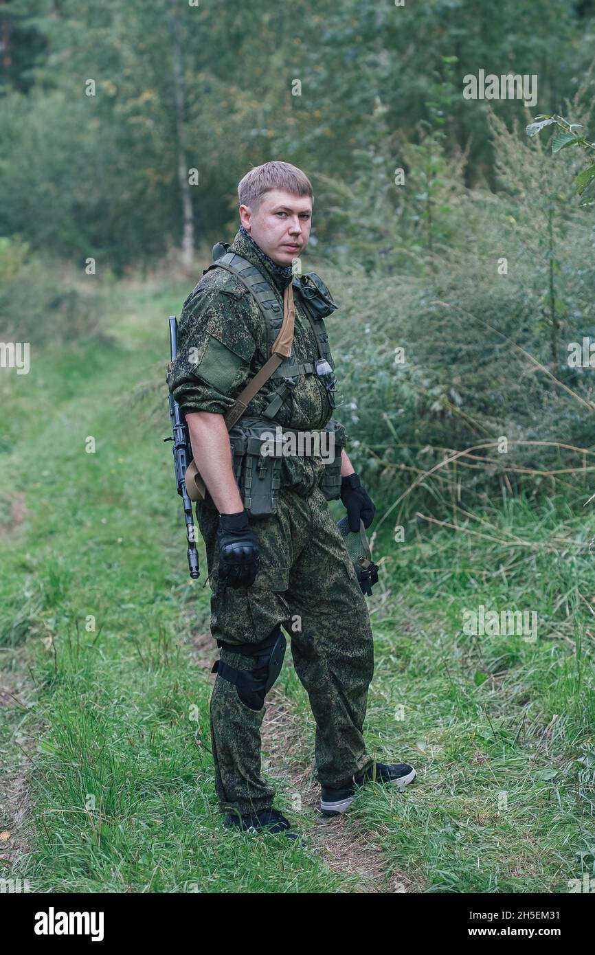 Fully equipped military men with automatic weapons getting ready to ...