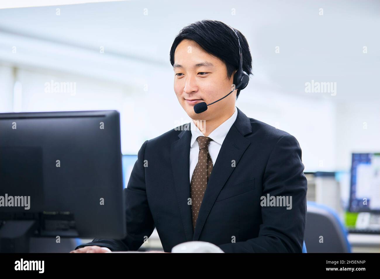 Asian male reception desk hi-res stock photography and images - Alamy