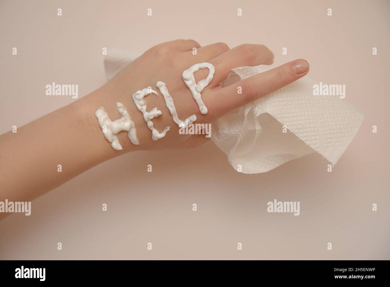 Concept of painful dry skin. Sign help written with cream on woman's ...