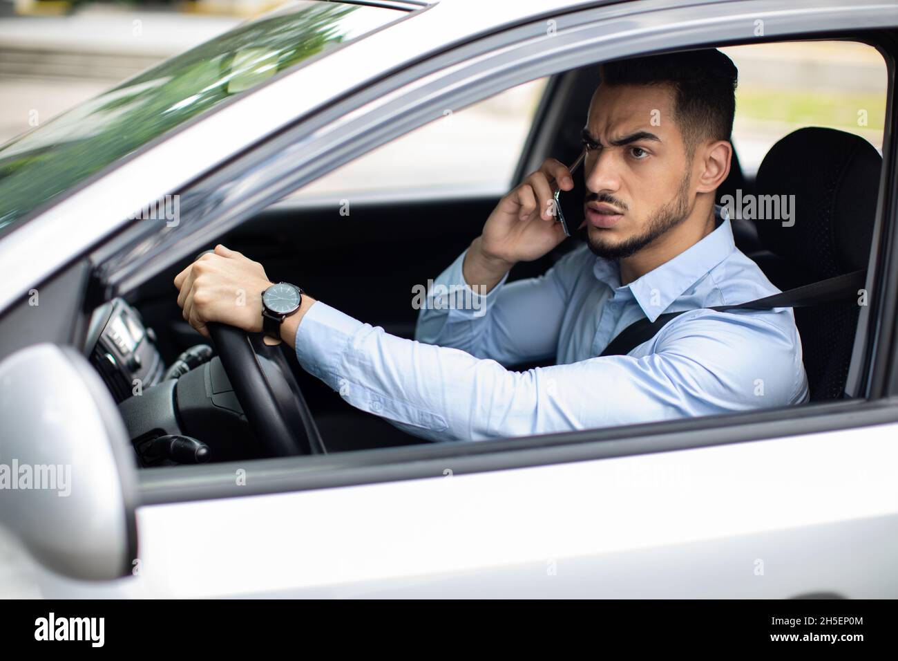 Angry arabic guy manager fighting on phone while driving auto Stock ...