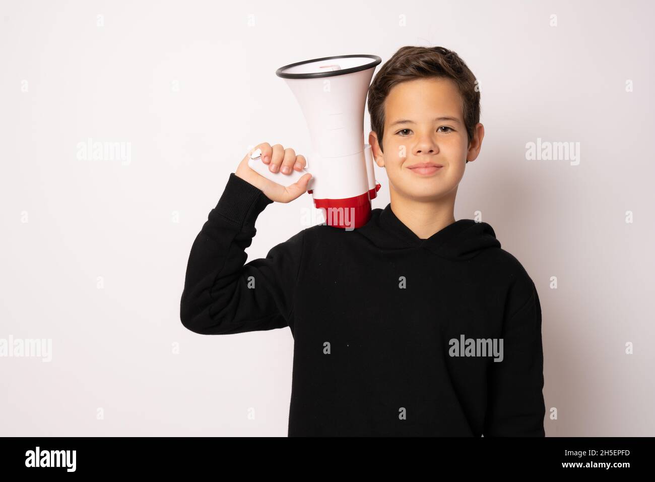 Cute little boy holding megaphone isolated over white background Stock ...