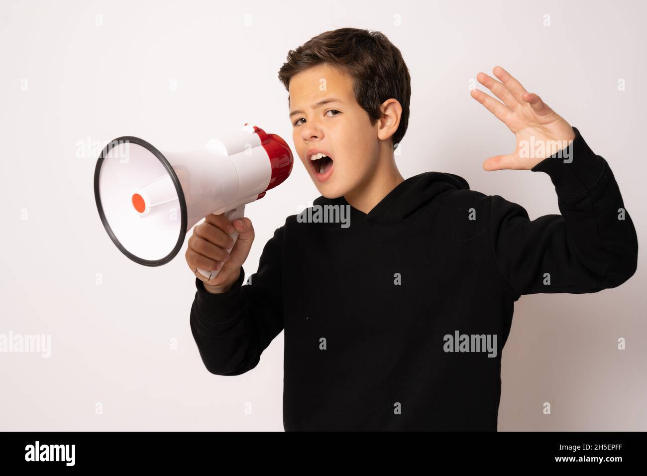 Cute little boy with megaphone on white background Stock Photo - Alamy