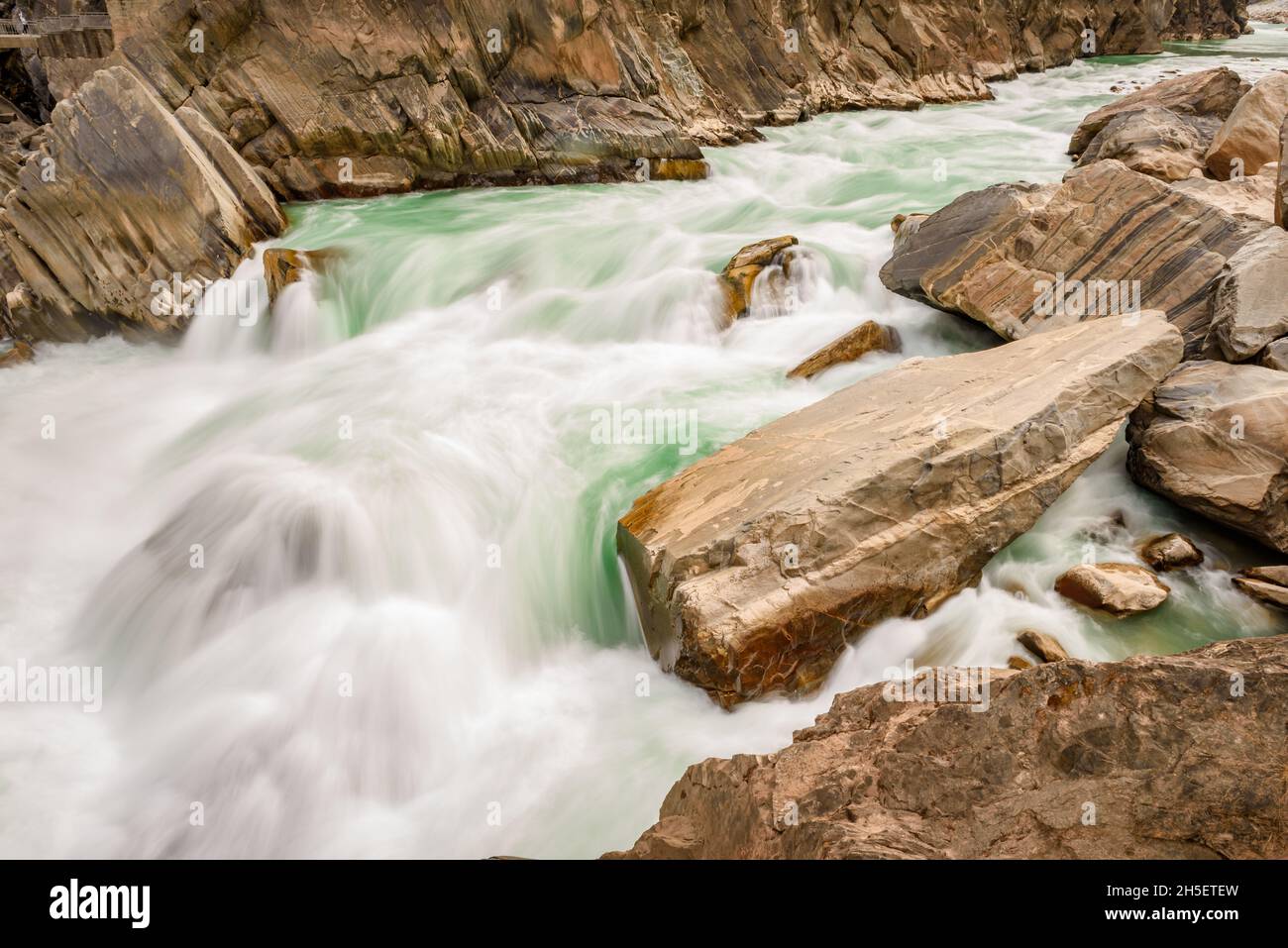 Fast flowing river at Tiger Leaping Gorge, a scenic canyon along Jinsha ...