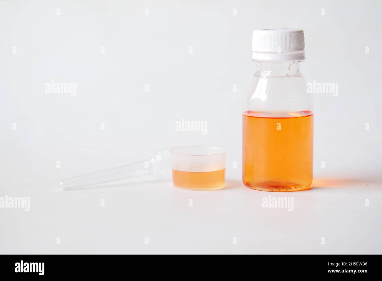 liquid medicine in a container on white background Stock Photo - Alamy