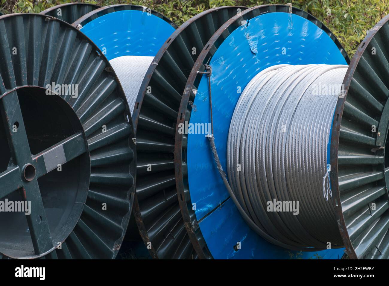 large rolls of coiled silver metal power cables Stock Photo - Alamy