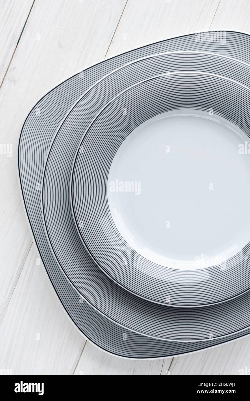 A classic set of porcelain plates of different shapes and sizes. For ...