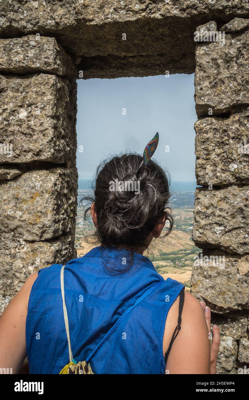 A Girl looking out a window of a medieval castle in San Marino, Italy ...