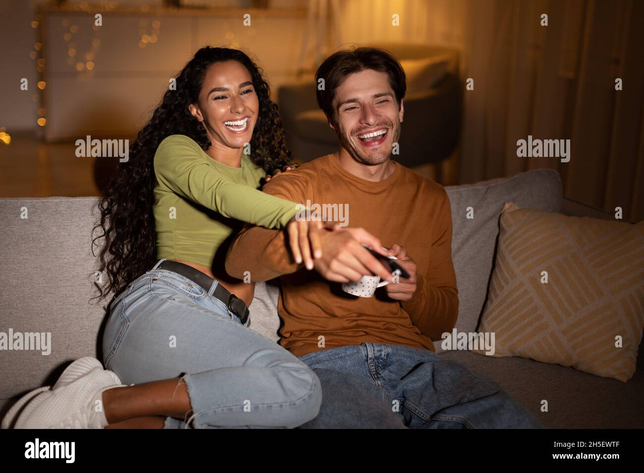 Couple Watching TV Having Fun Enjoying Comedy Film At Home Stock Photo ...