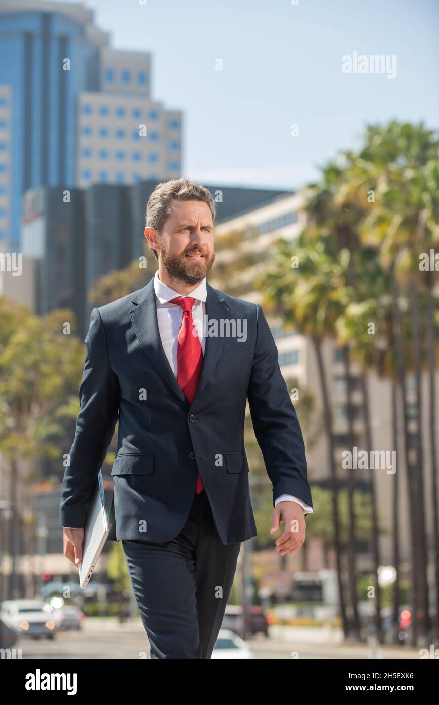 Professional man walking laptop computer hi-res stock photography and ...