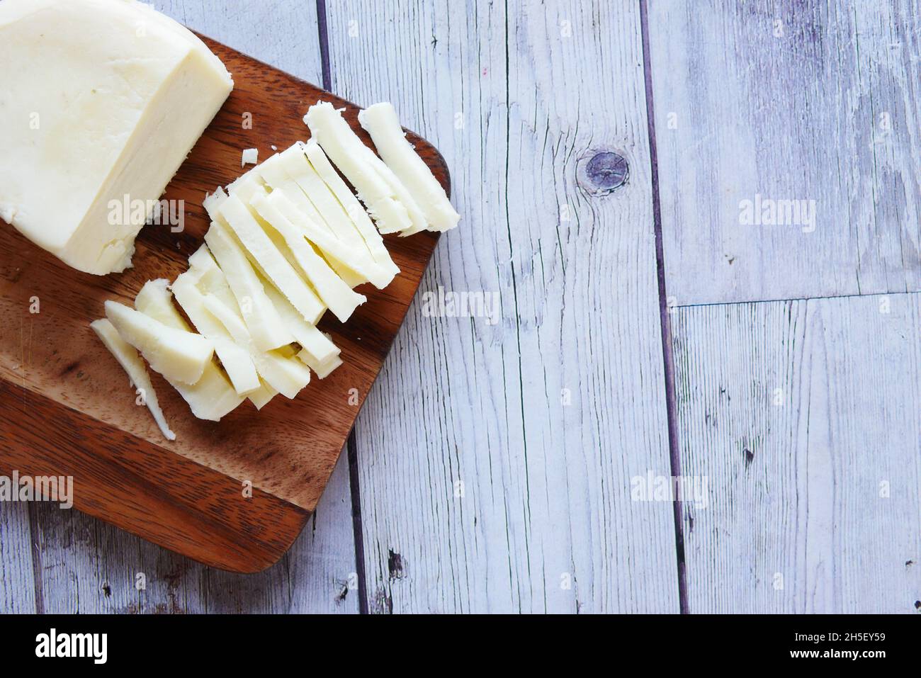 close up of fresh cheese on a chopping board on table Stock Photo - Alamy