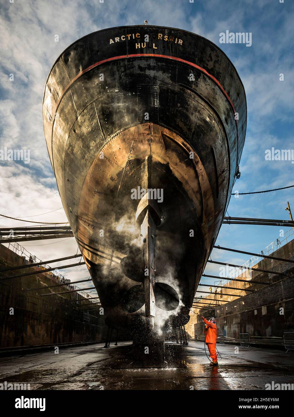 Ken Knaggs cleans propeller of the Arctic Corsair, as the restoration ...