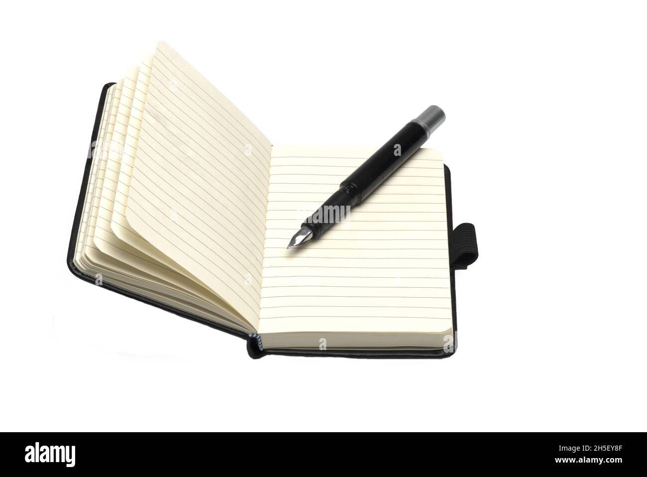 Close up of opened vintage leather notebook with fountain pen isolated ...