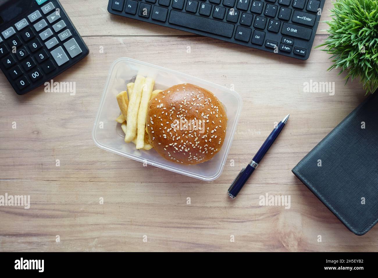 beef burger and french friend in a lunch box on office desk Stock Photo ...