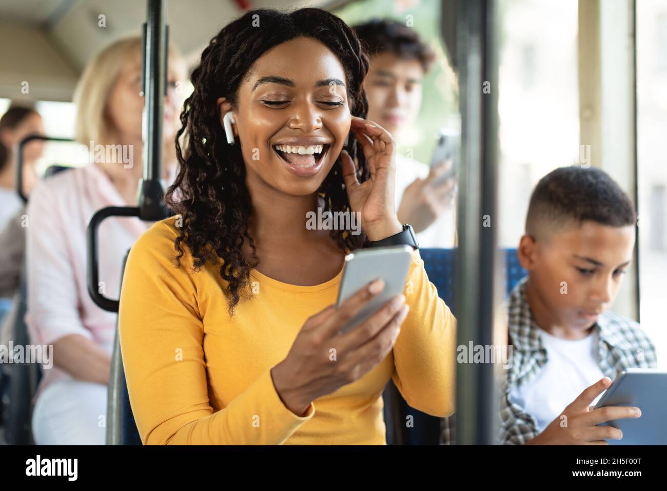 Woman in tram using smartphone hi-res stock photography and images - Alamy