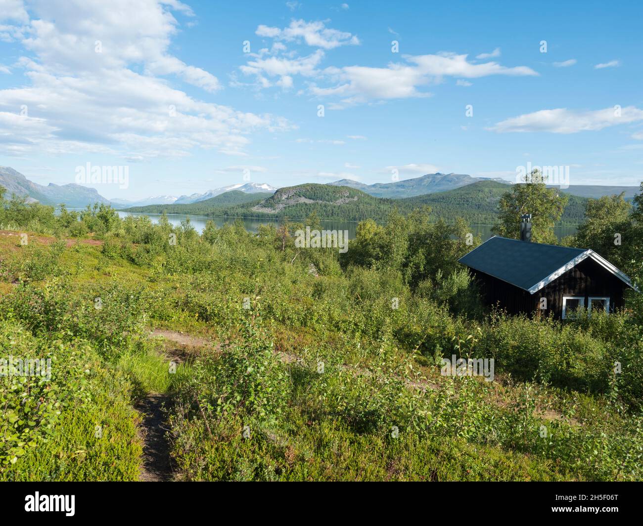 Mountain lodge on the shore of lake Lulealven, Lule river dam in ...
