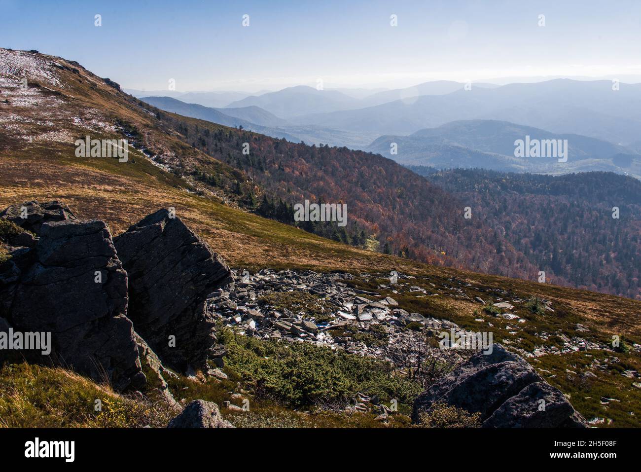 View of hills of Water Dividing ridge covered in red, orange and yellow ...