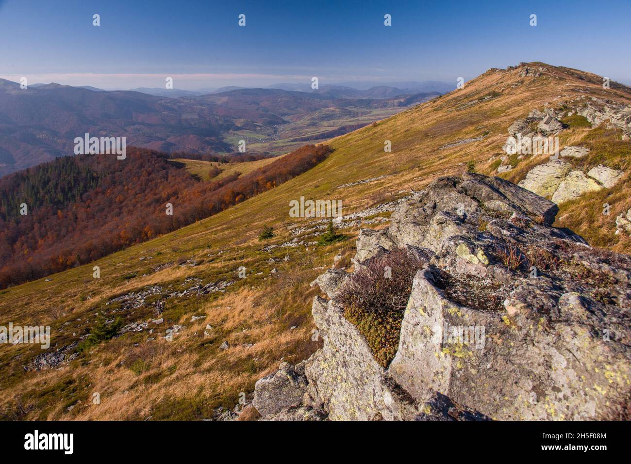 View of hills of Water Dividing ridge covered in red, orange and yellow ...