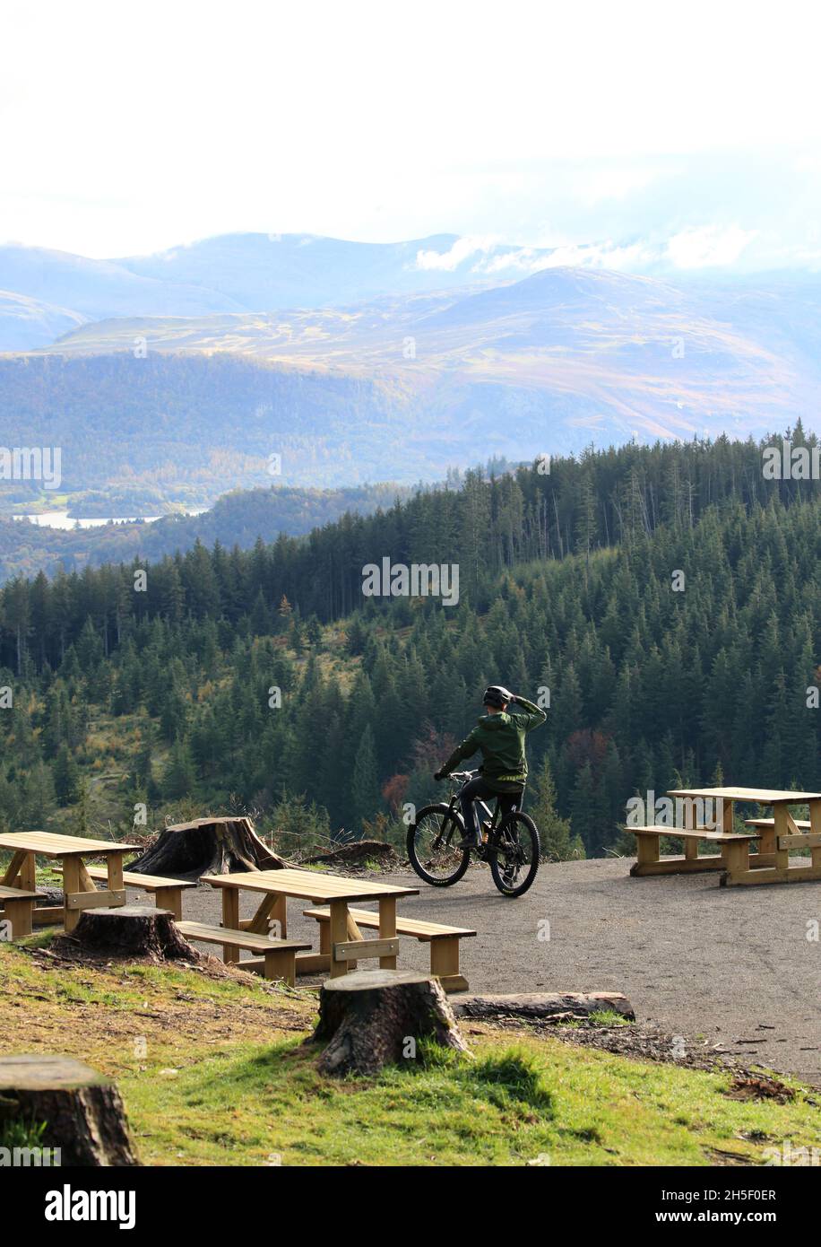 A mountain biker enjoying a view of the Lake district from Whinlatter ...