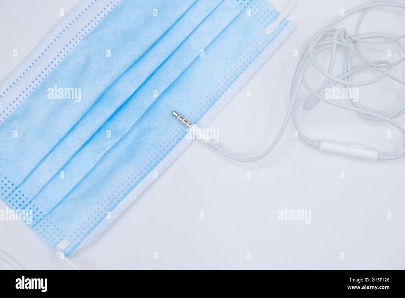 Face mask and mini jack connector from a smartphone headset Stock Photo ...