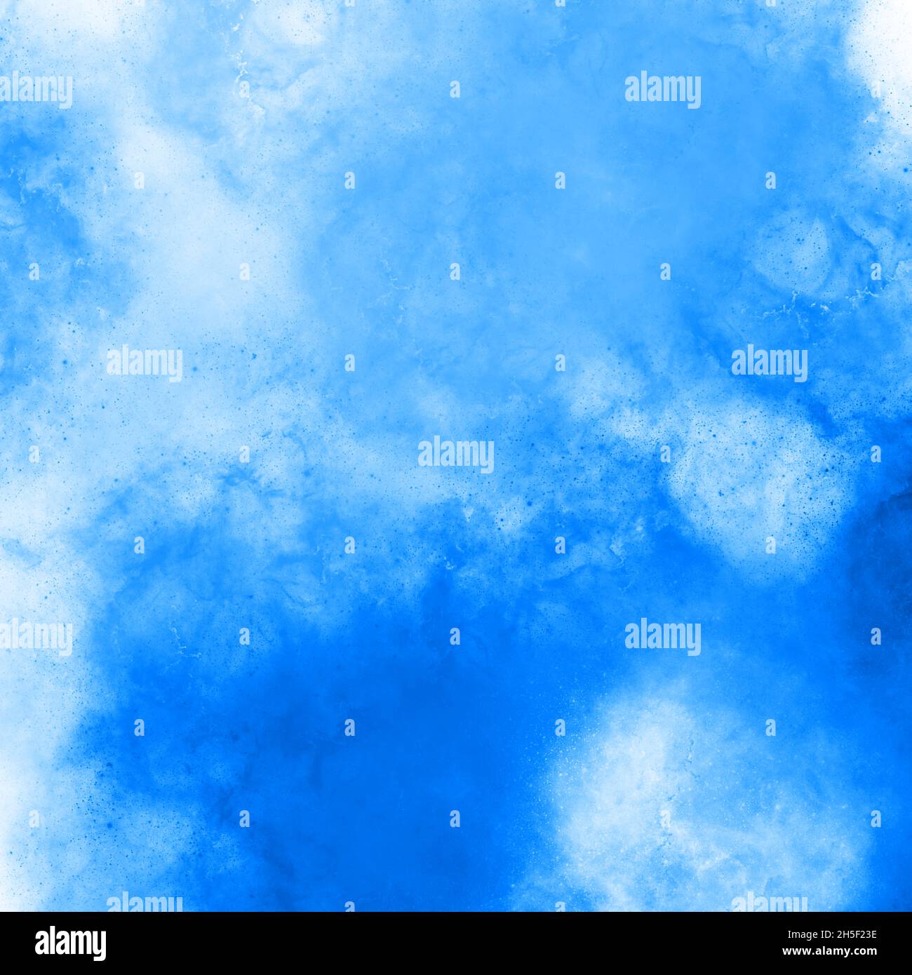 Light blue abstract background with spots of paint and small splashes ...