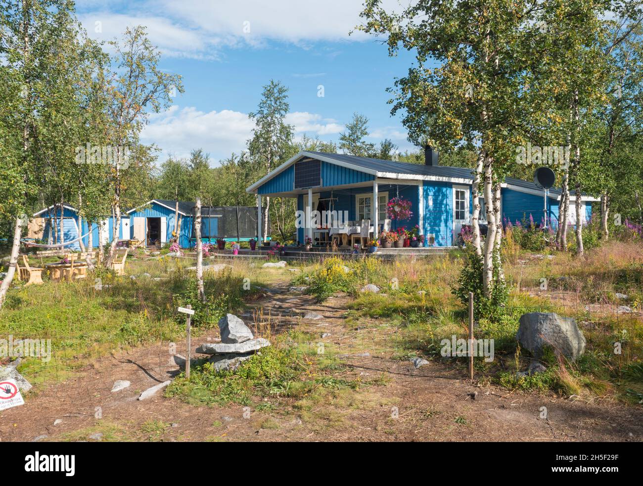 Beautiful blue sami or saami country house at Sitojaure lake shore with ...
