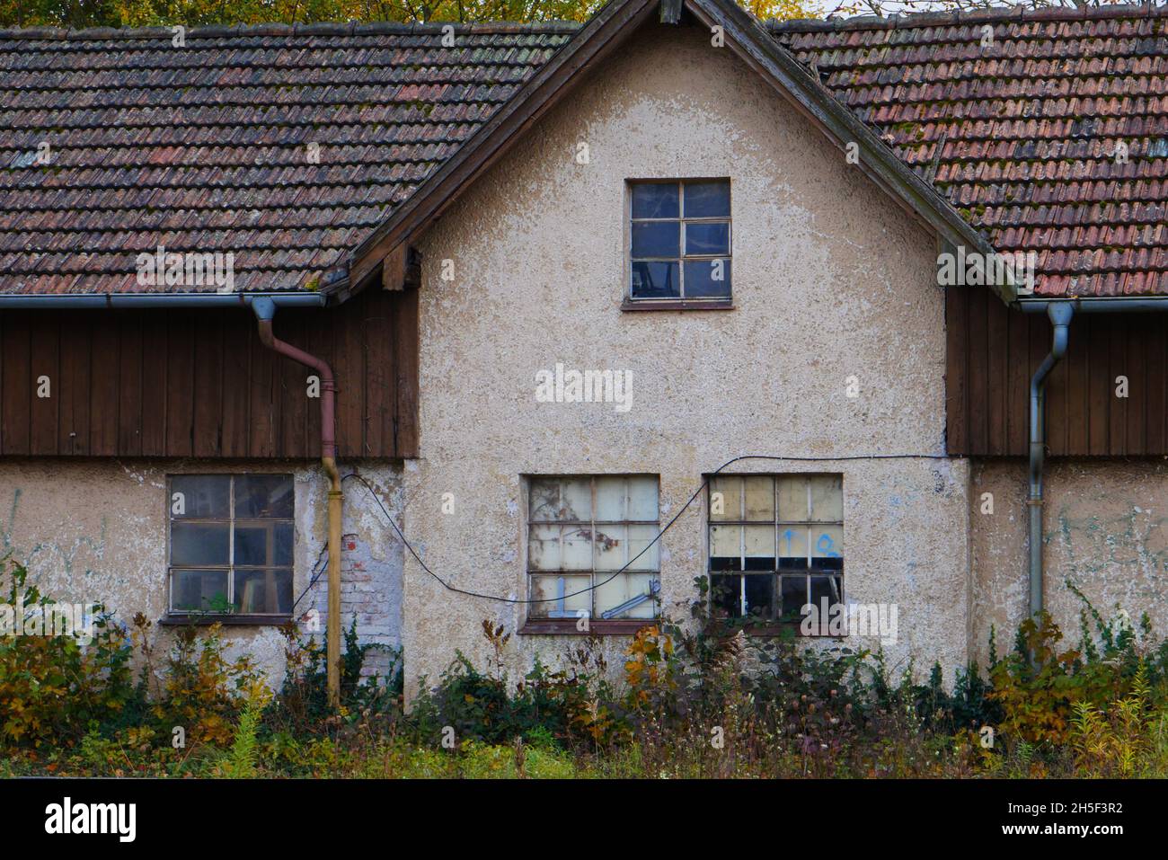 old dilapidated building with broken windows and defective facade ...