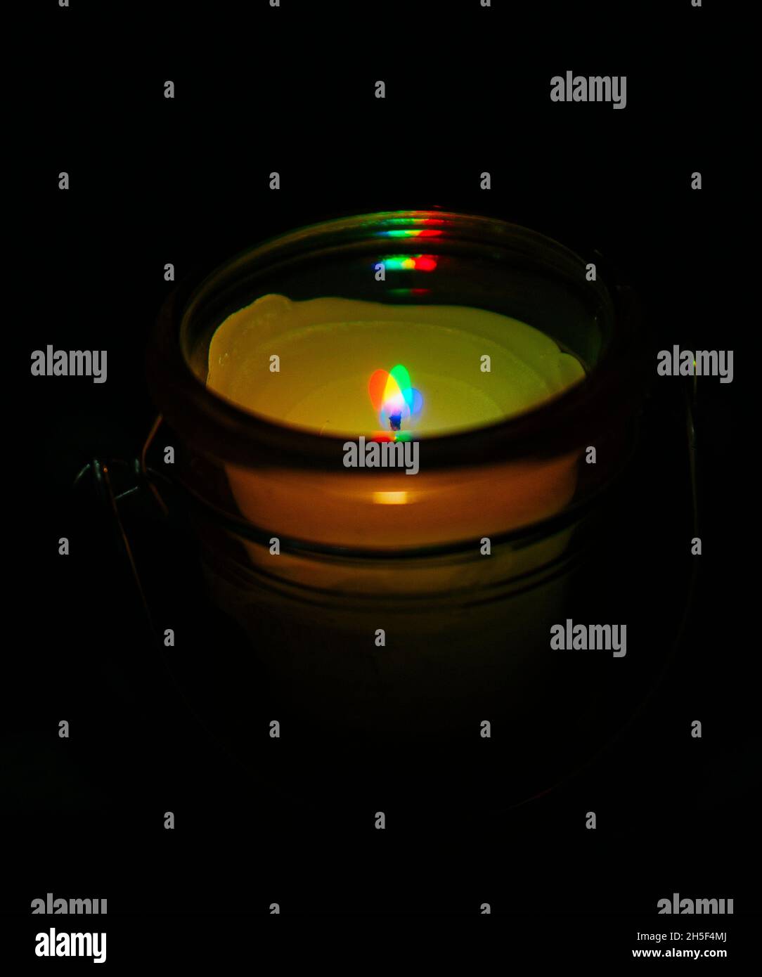 Harris Shutter effect small scented candle flame Stock Photo - Alamy