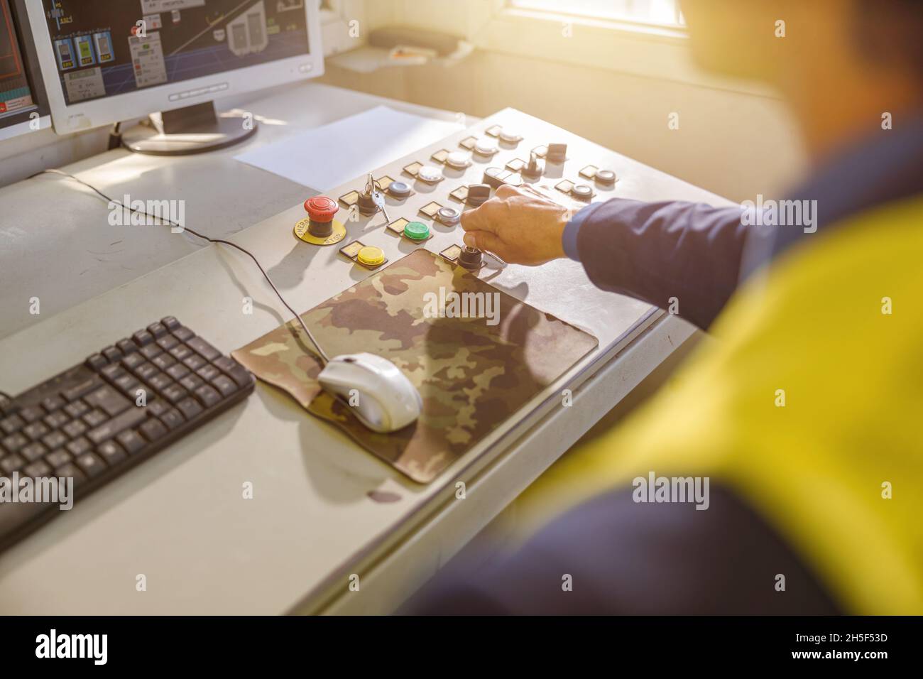 Male engineer using control panel at factory Stock Photo - Alamy