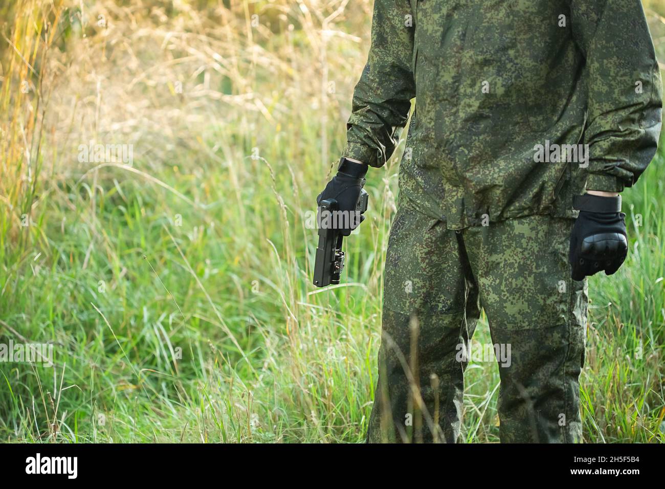 Fully equipped military men with automatic weapons getting ready to ...
