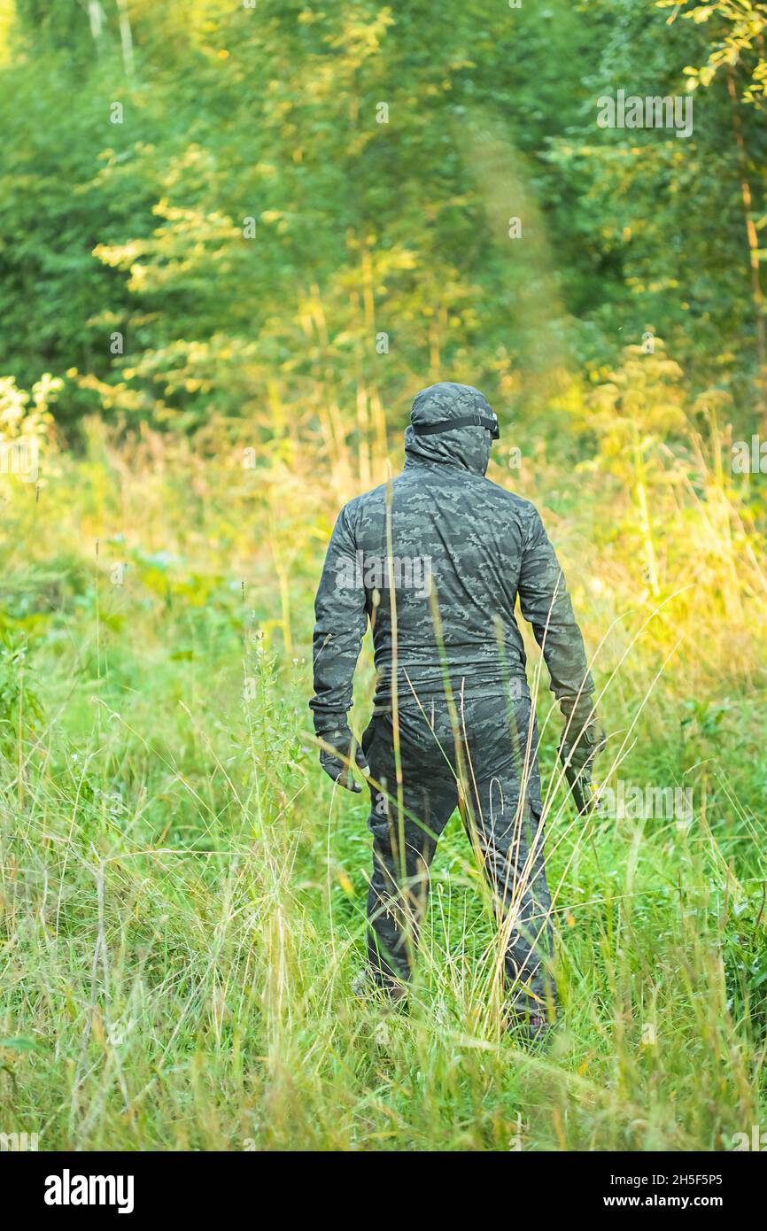 Fully equipped military men with automatic weapons getting ready to ...