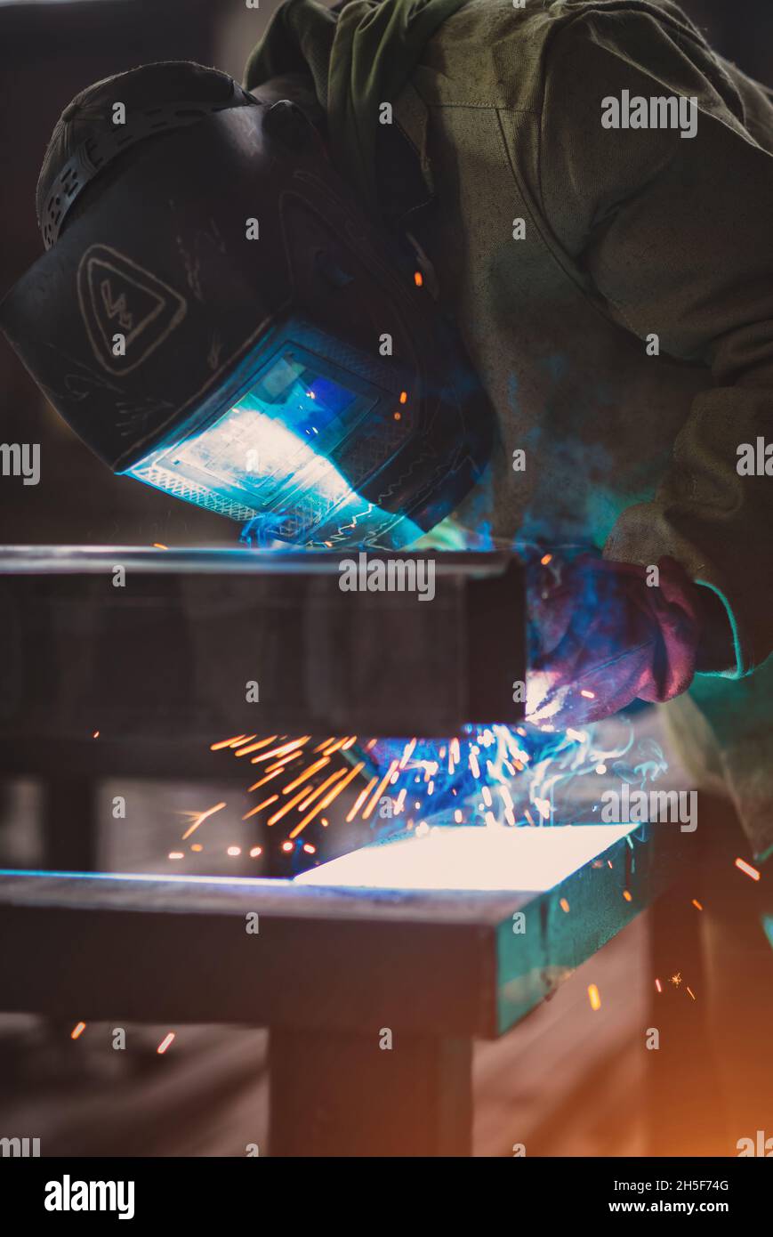 A welder with a welding machine works in a factory Stock Photo - Alamy