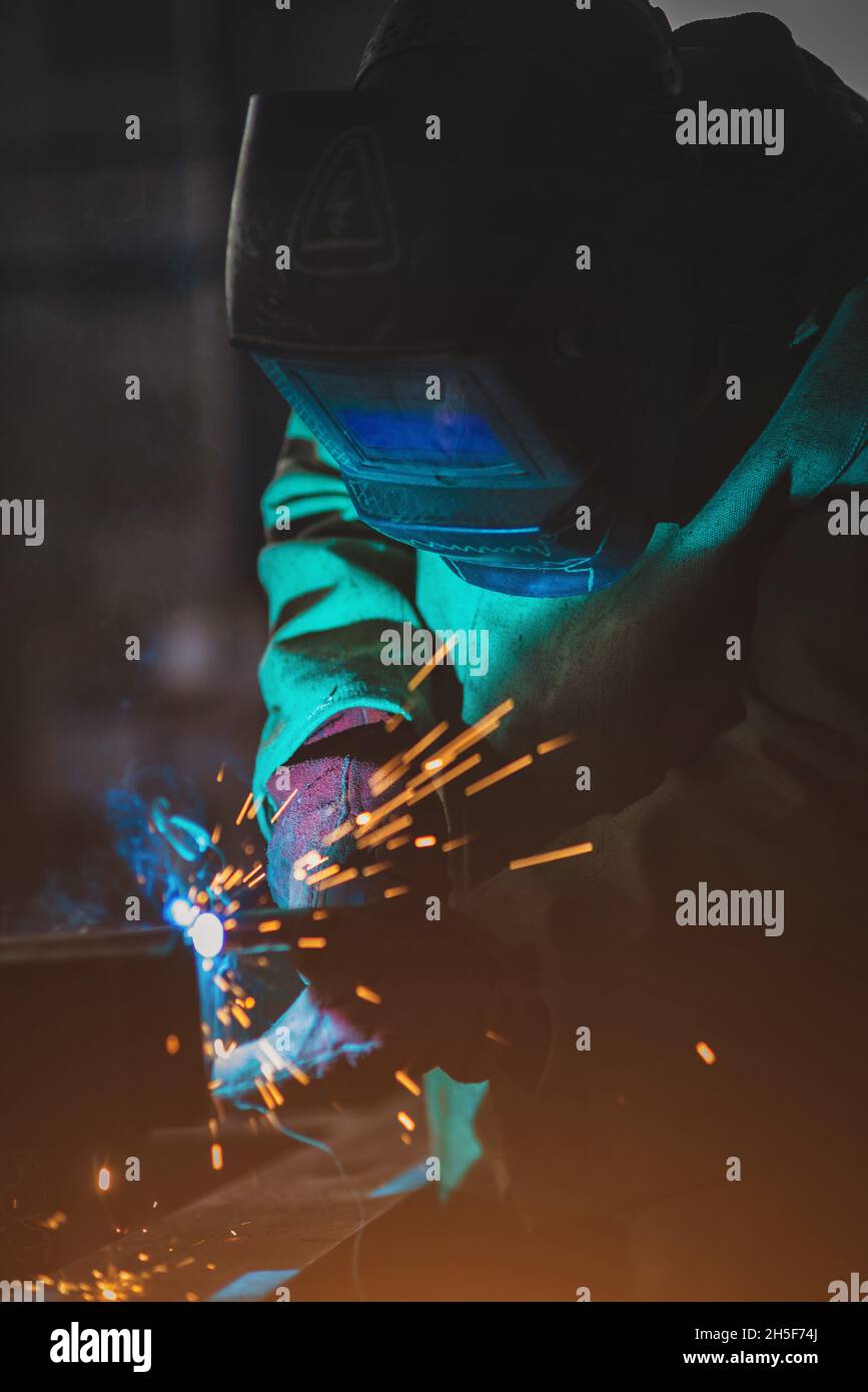 A welder with a welding machine works in a factory Stock Photo - Alamy