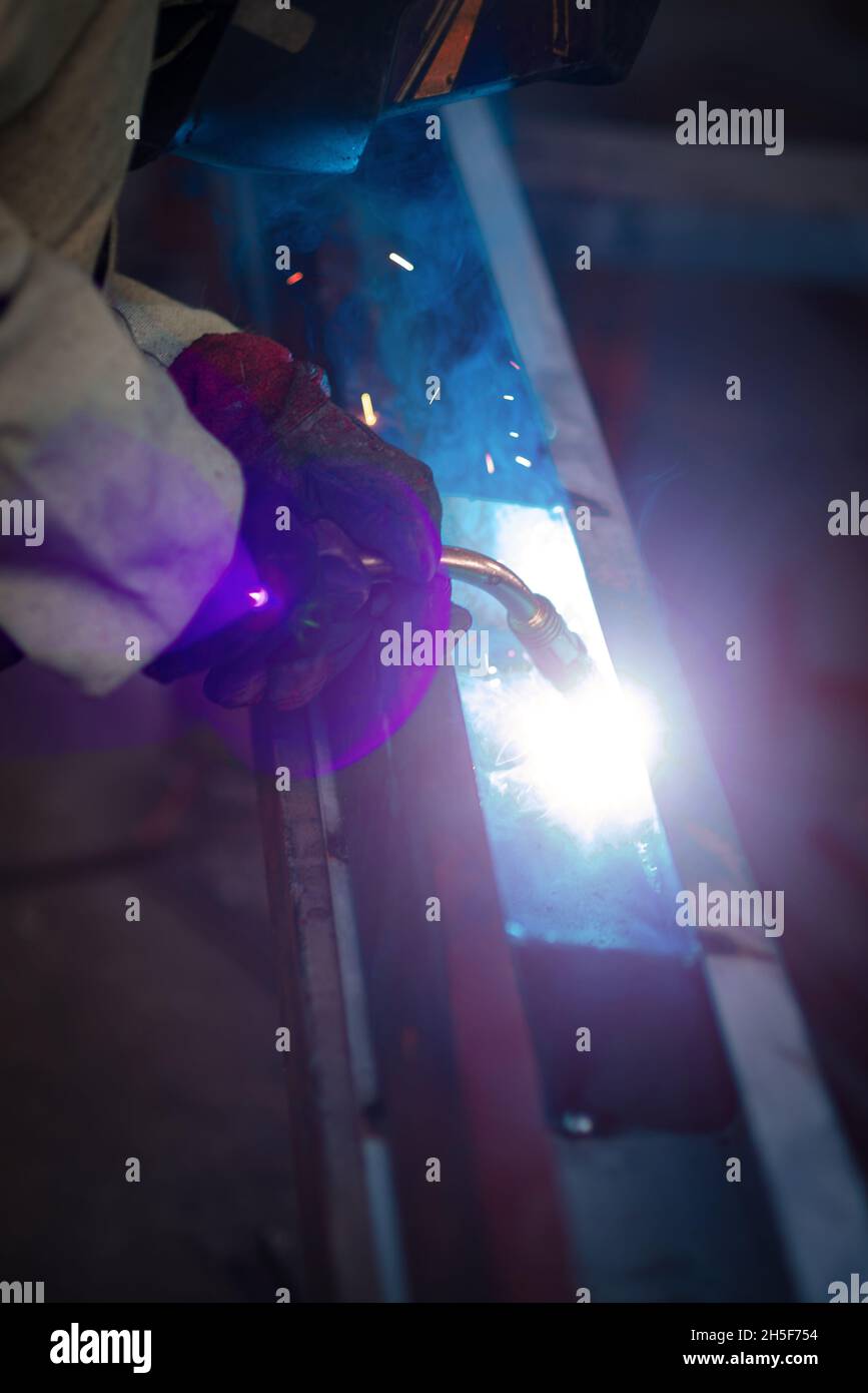Welder weld inside metal beam Stock Photo - Alamy