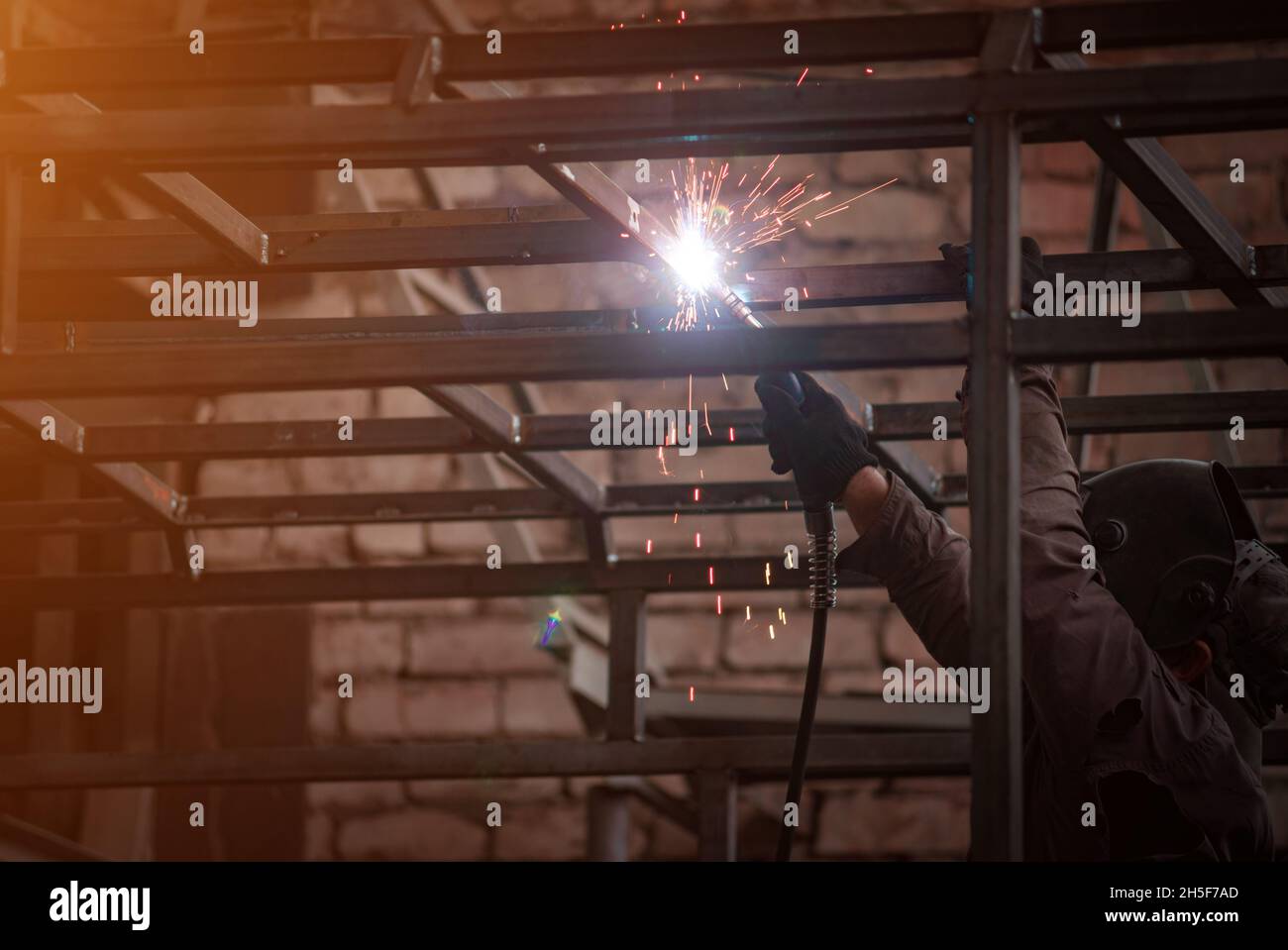 Welder weld frame iron construction Stock Photo - Alamy