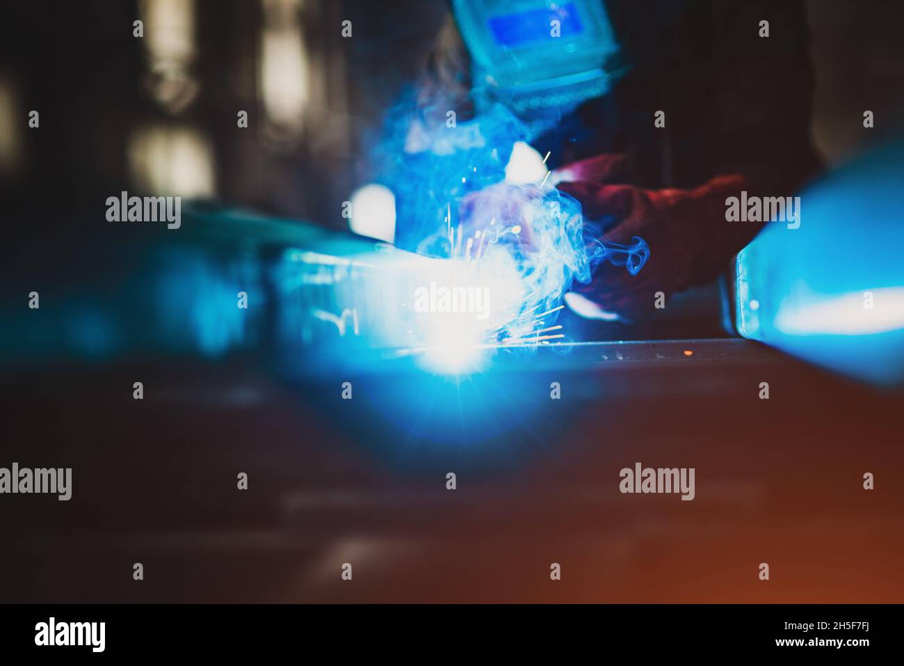 A welder with a welding machine works in a factory Stock Photo - Alamy