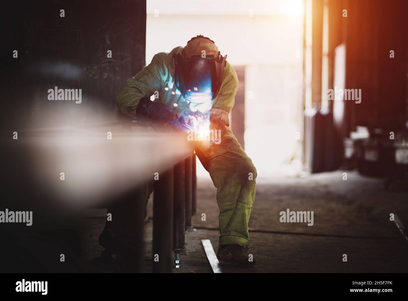 A welder with a welding machine works in a factory Stock Photo - Alamy
