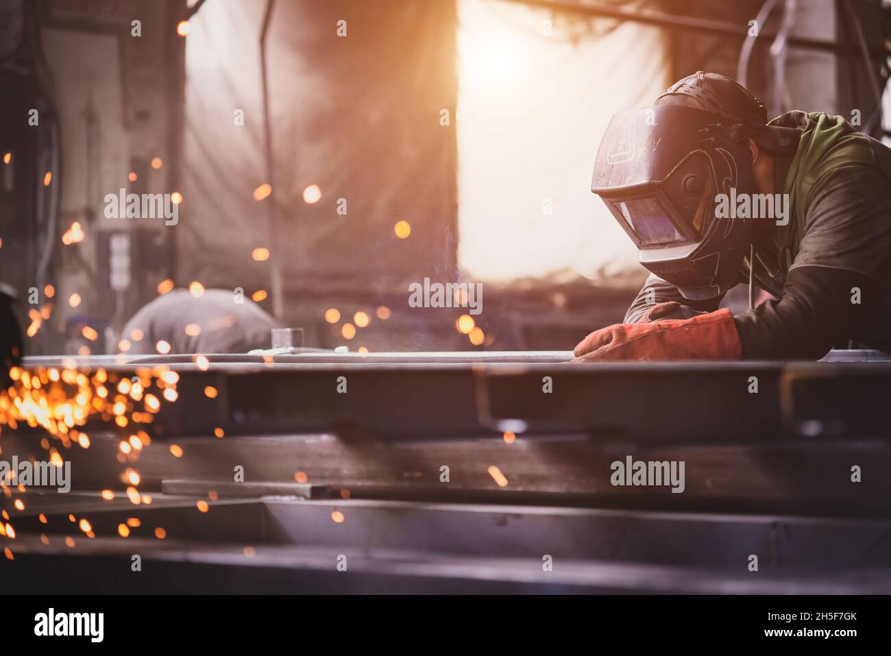 A welder with a welding machine works in a factory Stock Photo - Alamy