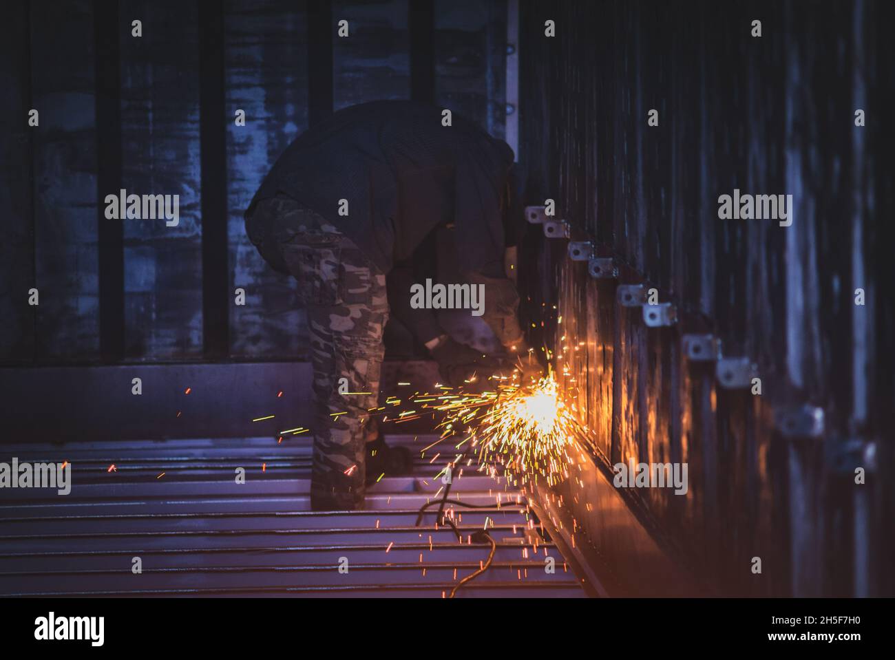 Welder makes welding inside an iron container Stock Photo - Alamy