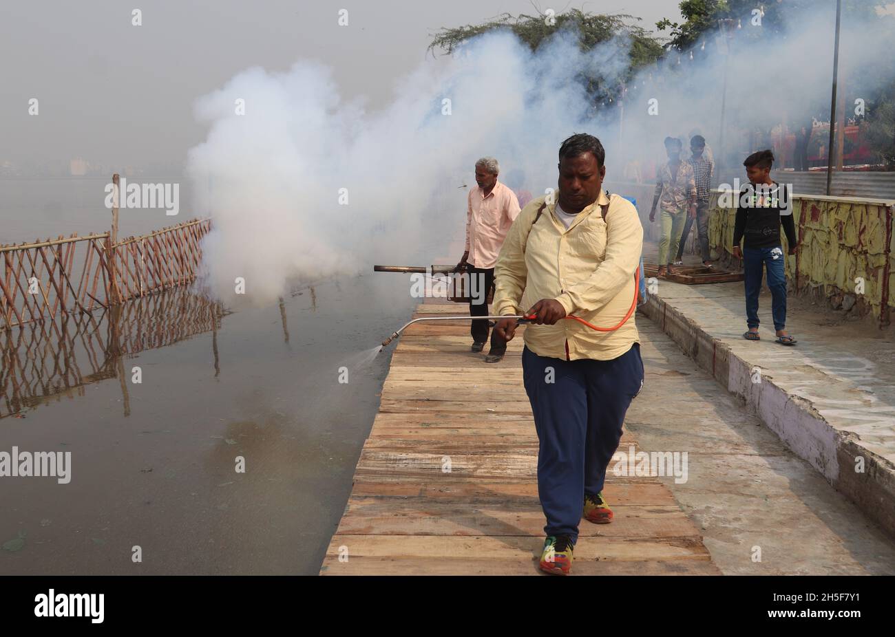 New Delhi, India. 09th Nov, 2021. Men spray disinfectants as a ...
