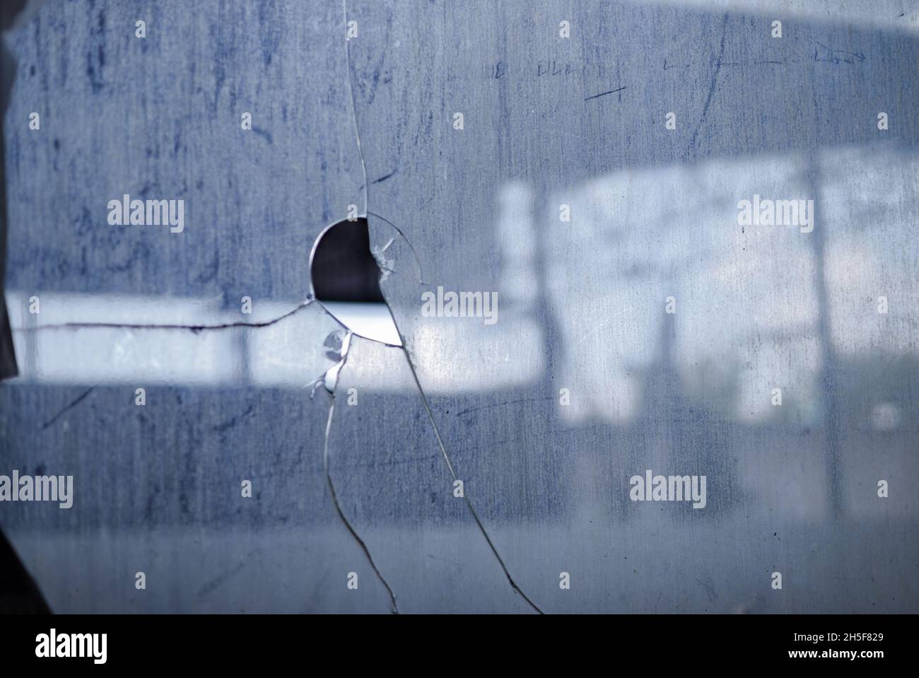 Dirty broken window glass with hole Stock Photo - Alamy