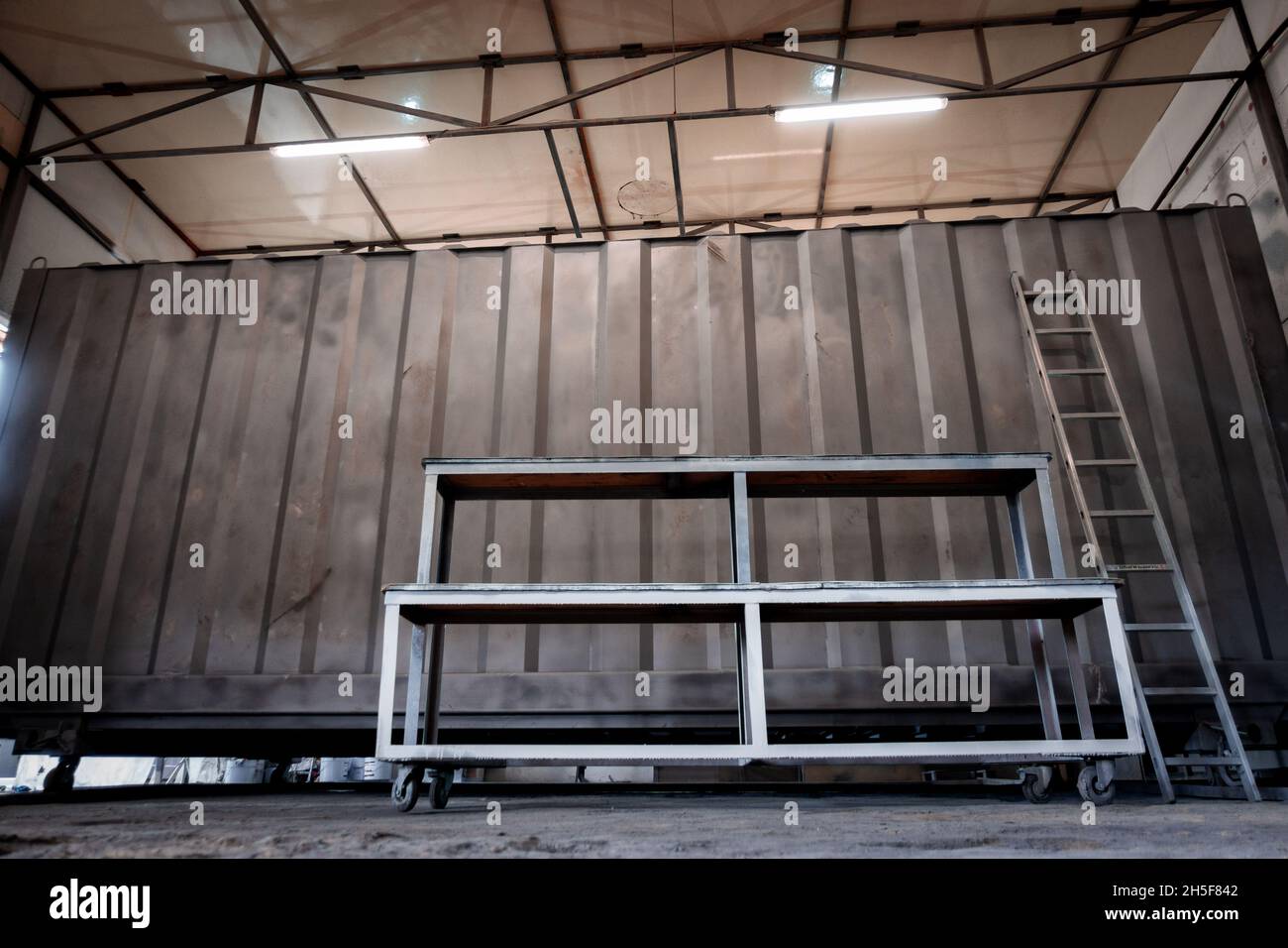 A large metal container stands for painting in the workshop Stock Photo ...