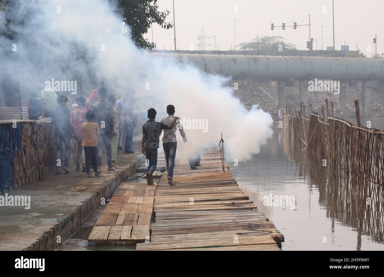 New Delhi, India. 09th Nov, 2021. Men spray disinfectants as a ...