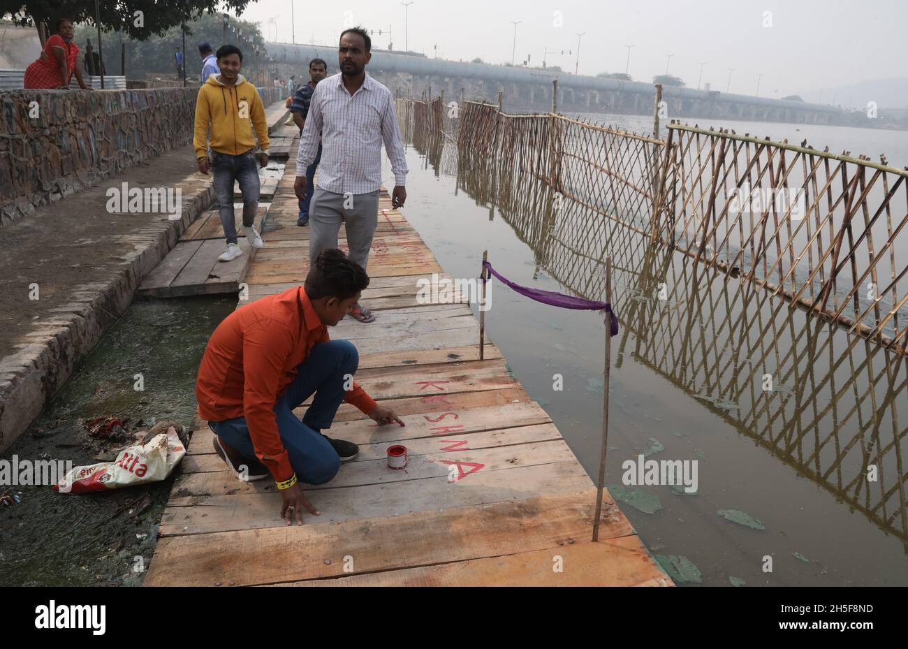 A devotee write his name on a wooden platform during the preparation of ...