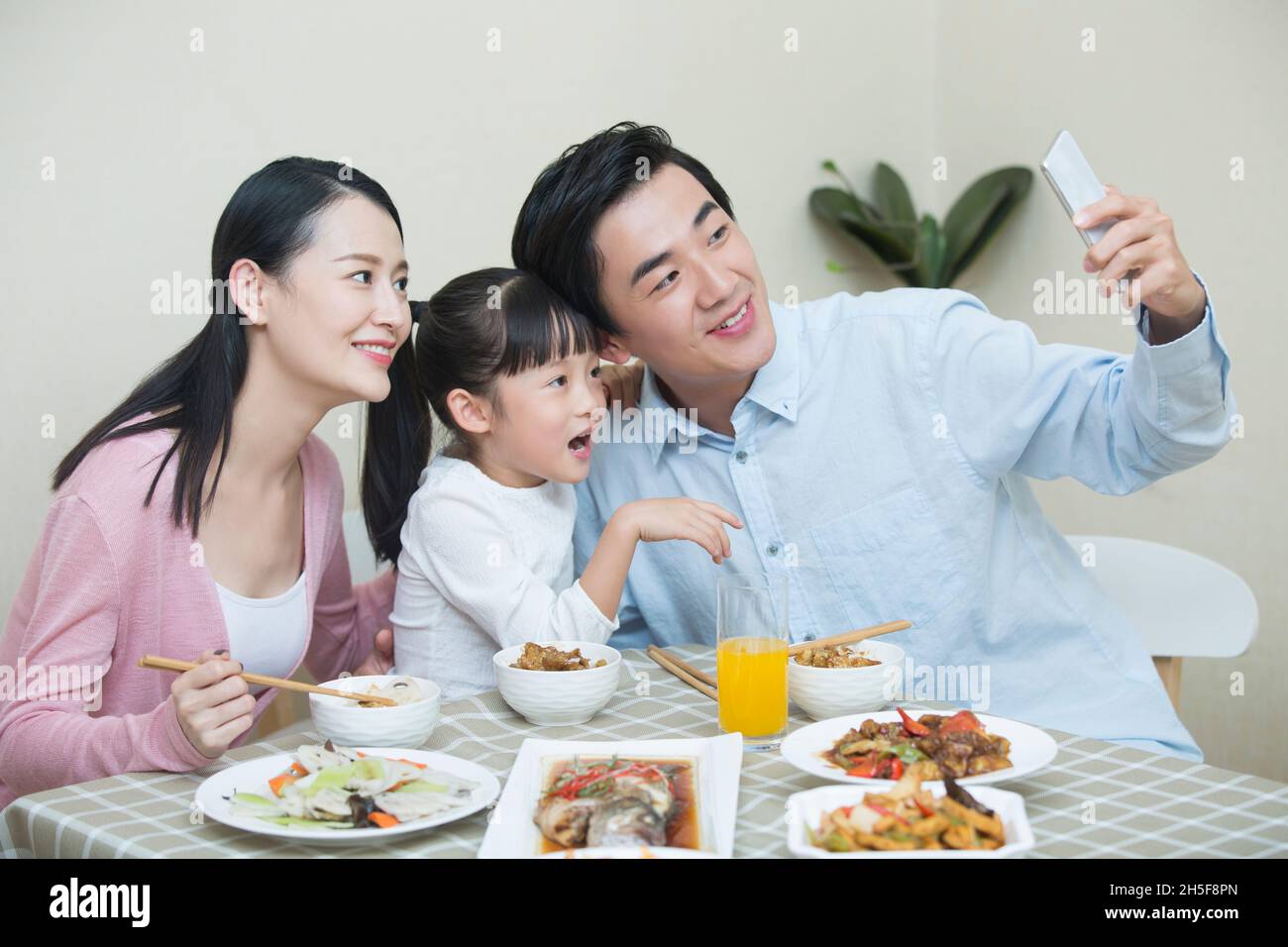 Happy meal for a family of three Stock Photo - Alamy