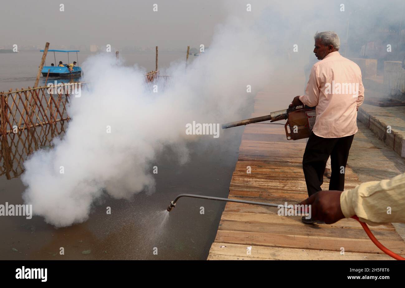 New Delhi, India. 09th Nov, 2021. Men spray disinfectants as a ...