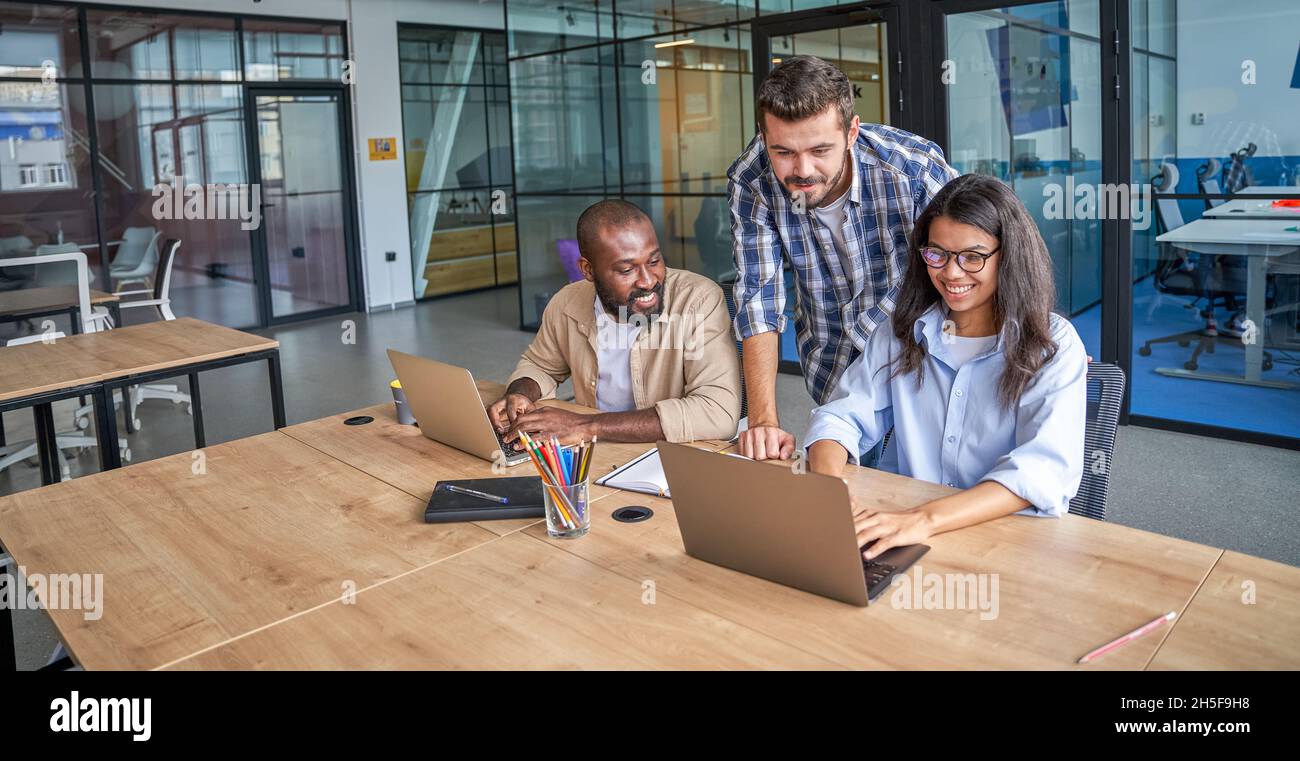 Employee discussing statement with experienced staff in conference room ...