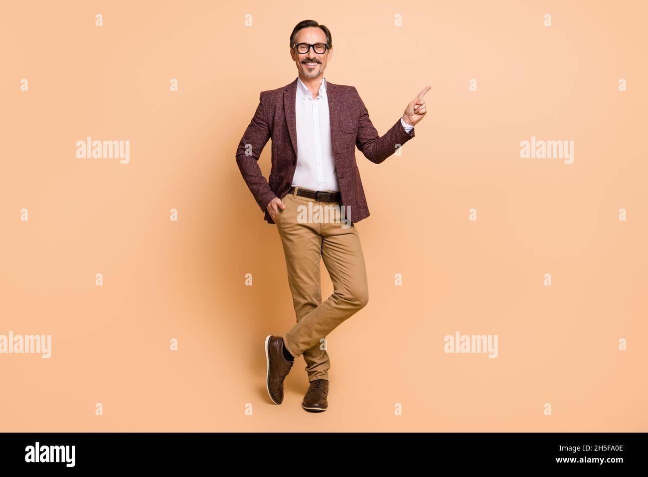 Full length body size view of attractive cheery man demonstrating copy ...