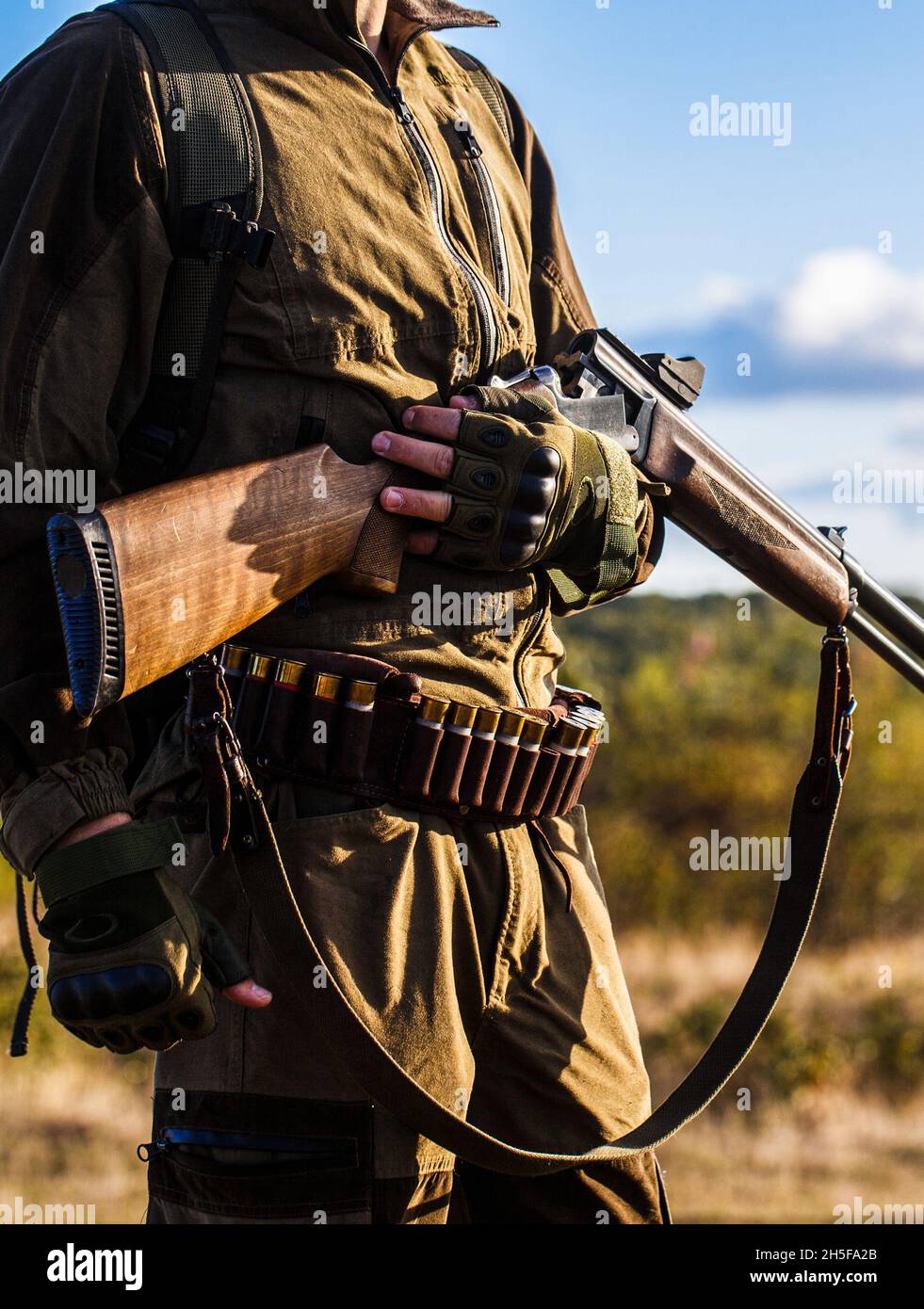 Male with a gun, rifle. Man is charging a hunting rifle. Process of ...
